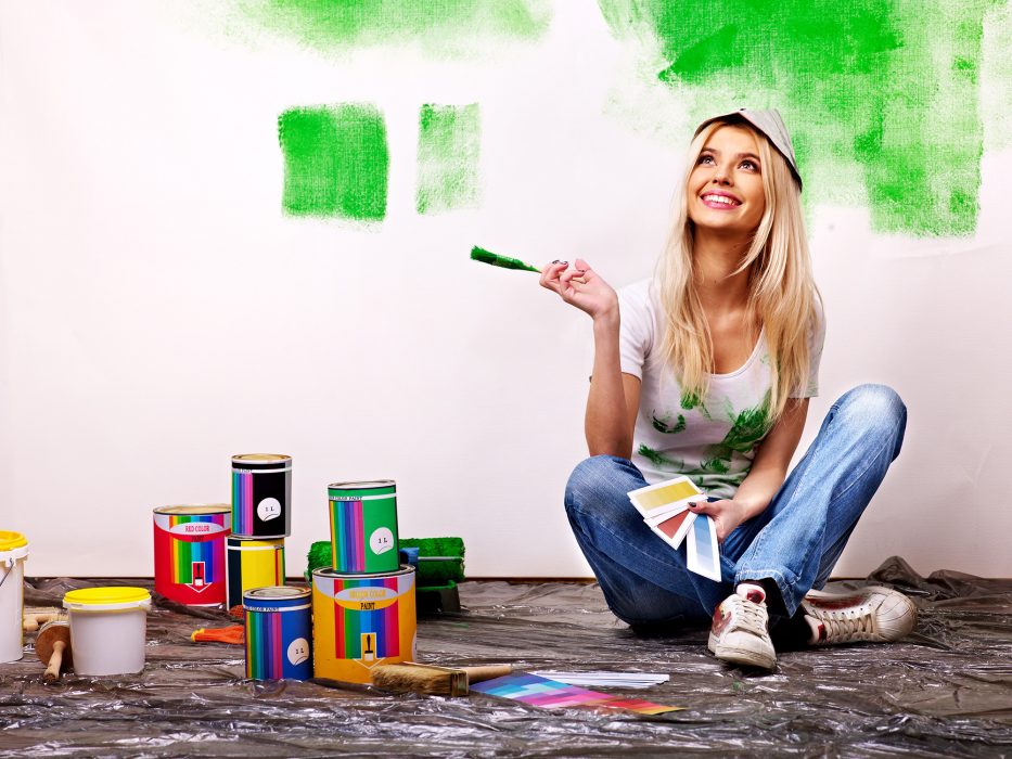 Woman paint wall at home. - Colormaker Industries
